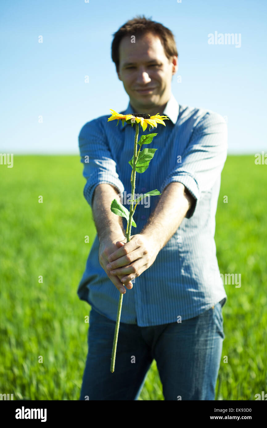 a young man and a sunflower field Stock Photo - Alamy