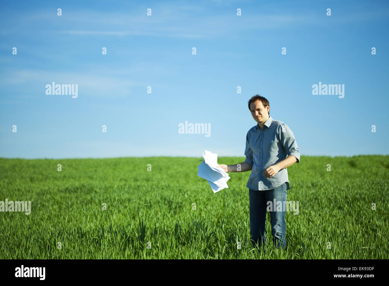 man throws the paper in the field Stock Photo - Alamy