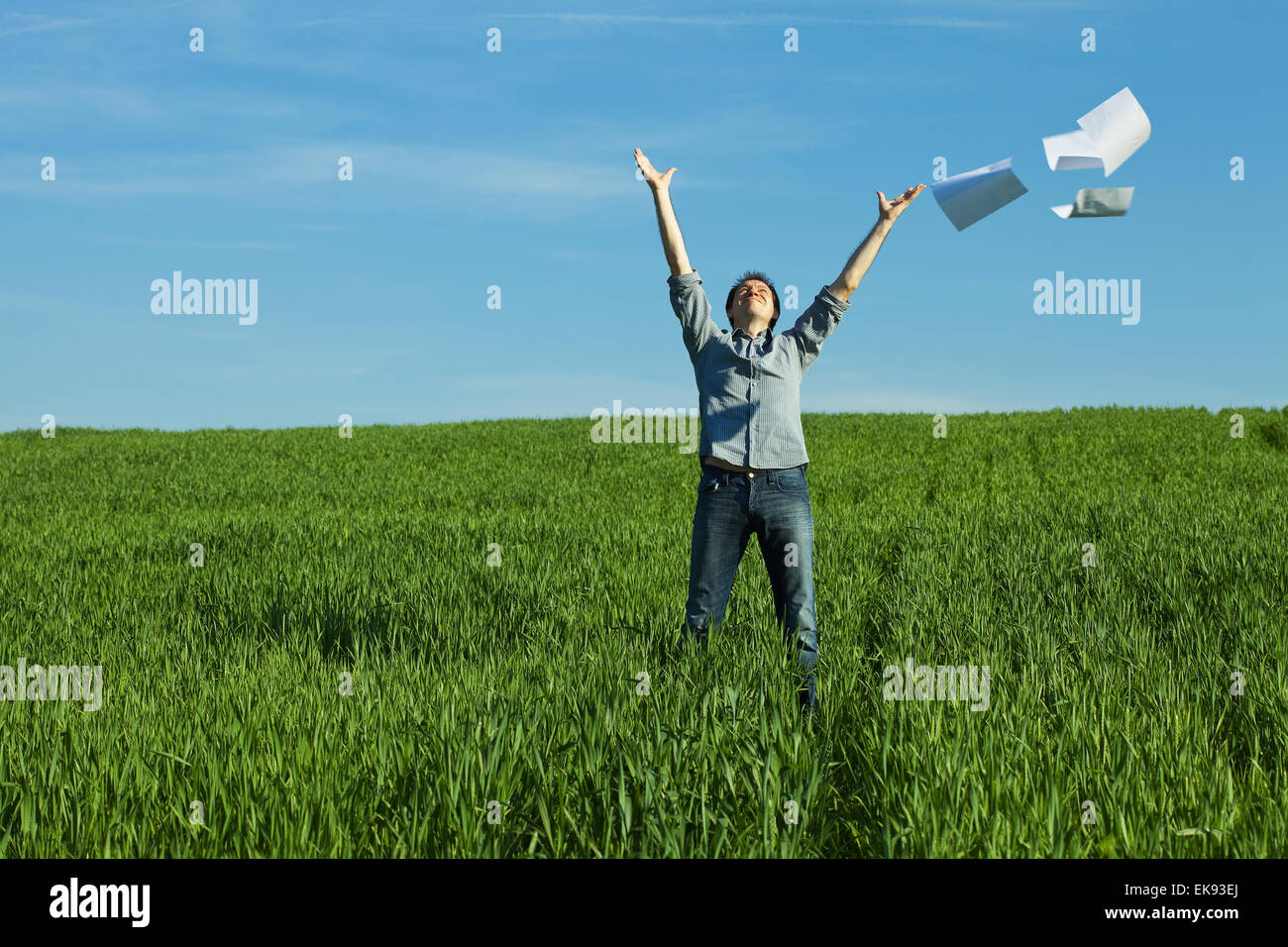 man throws the paper in the field Stock Photo - Alamy