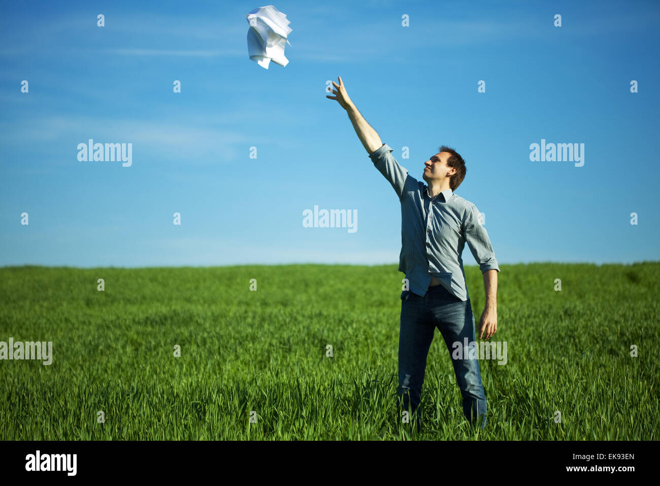 man throws the paper in the field Stock Photo - Alamy