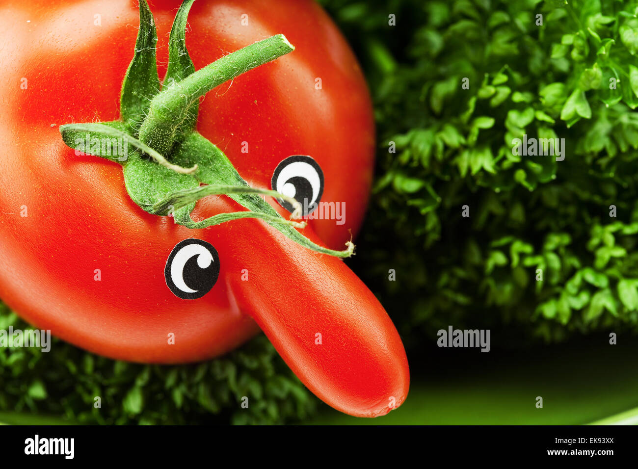 tomato with a nose and green Stock Photo - Alamy