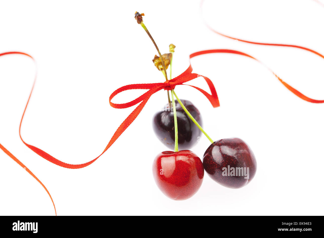 cherry with ribbon isolated on white Stock Photo - Alamy