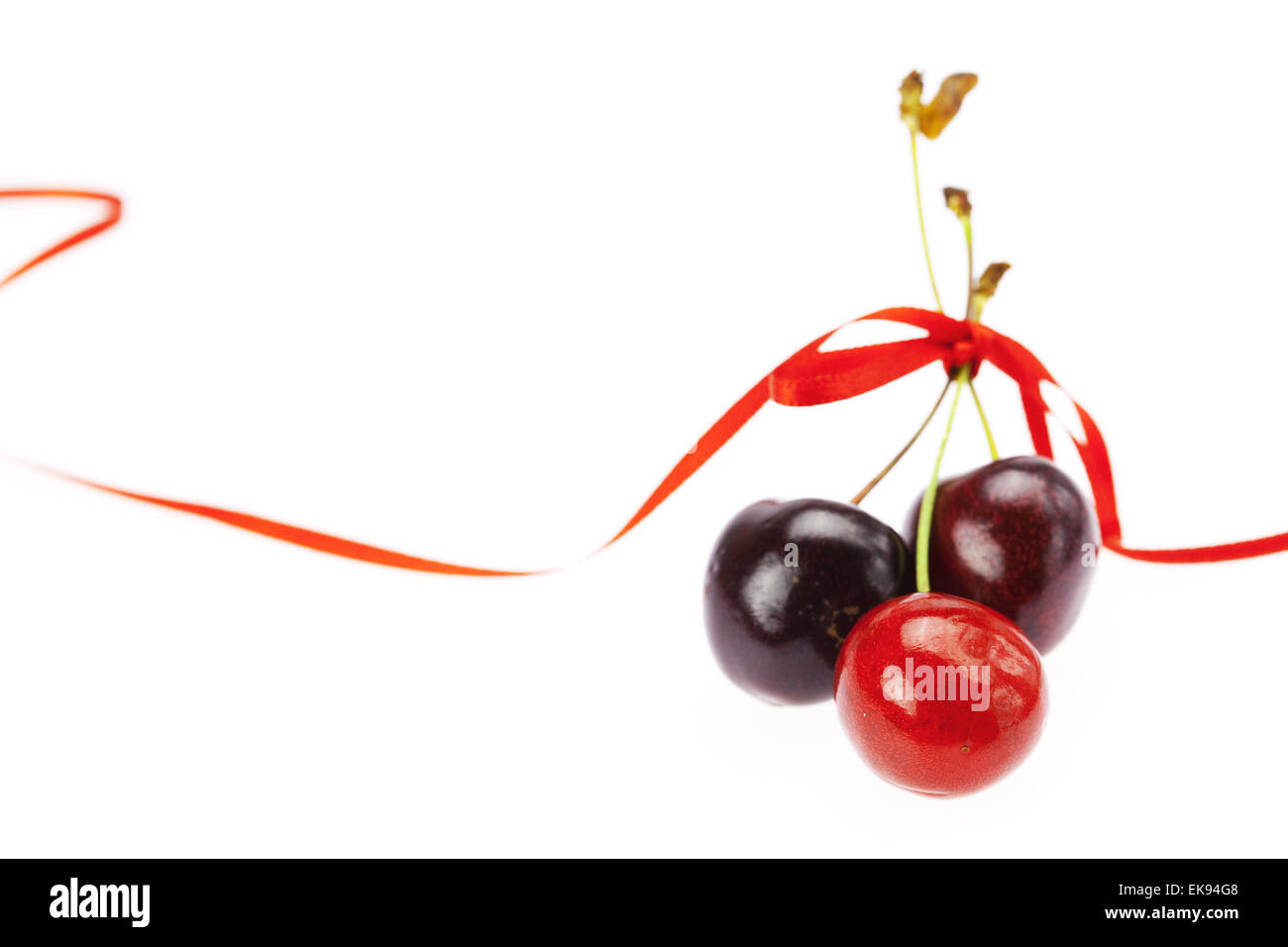 cherry with ribbon isolated on white Stock Photo - Alamy