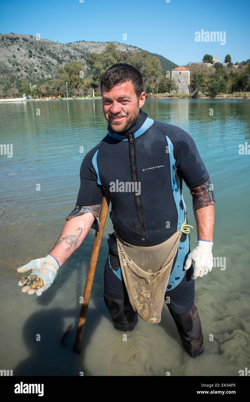 Digging for cockles in the Vivari channel with ancient Butrint in the ...