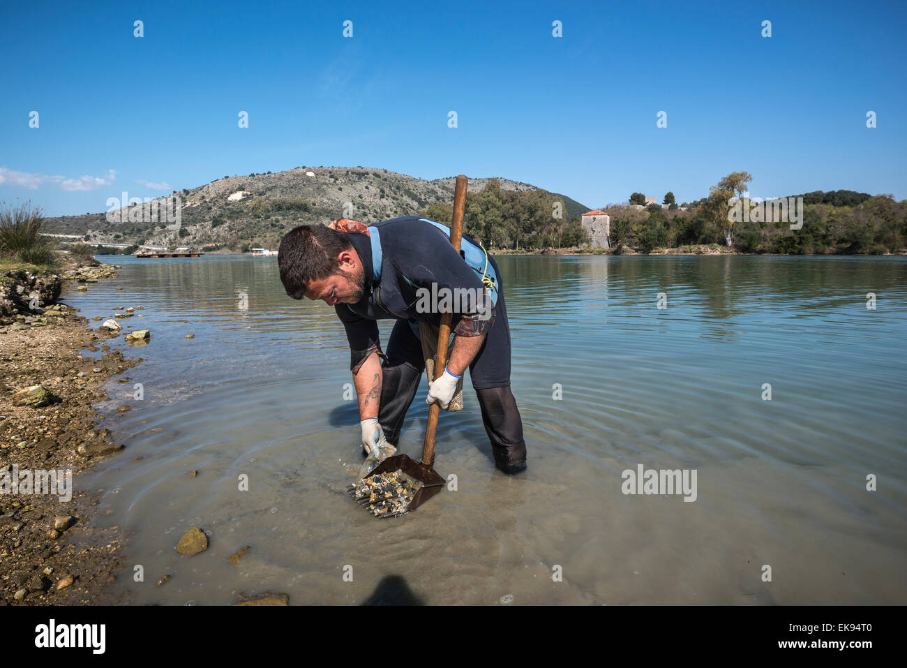Digging for cockles in the Vivari channel with ancient Butrint in the ...