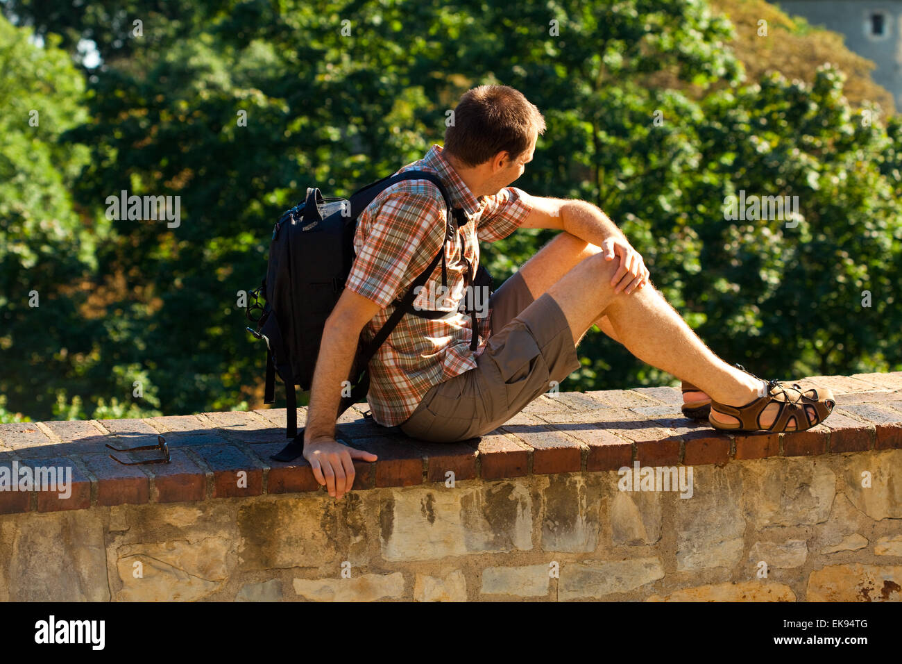 man sitting on a background of green foliage in Prague Stock Photo - Alamy