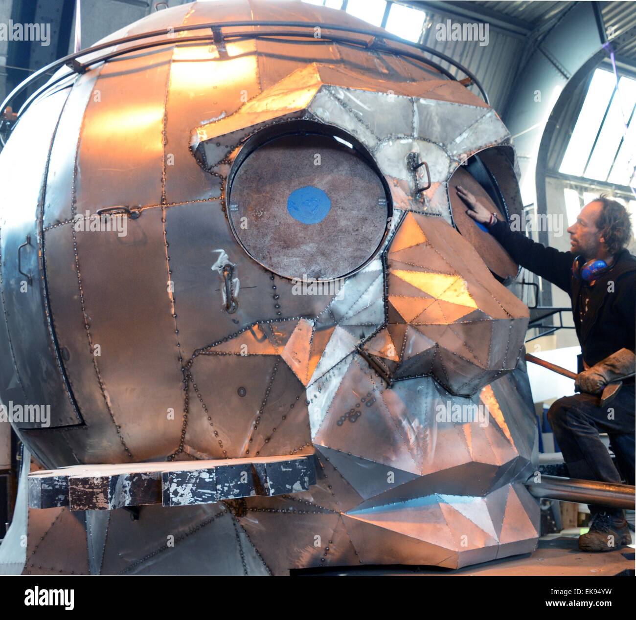 Artist Jan Rieve works on a larger than life lion head that represents ...