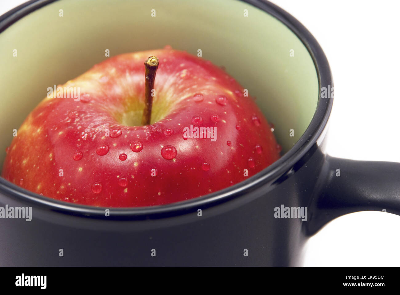 apple in a cup isolated on white Stock Photo - Alamy