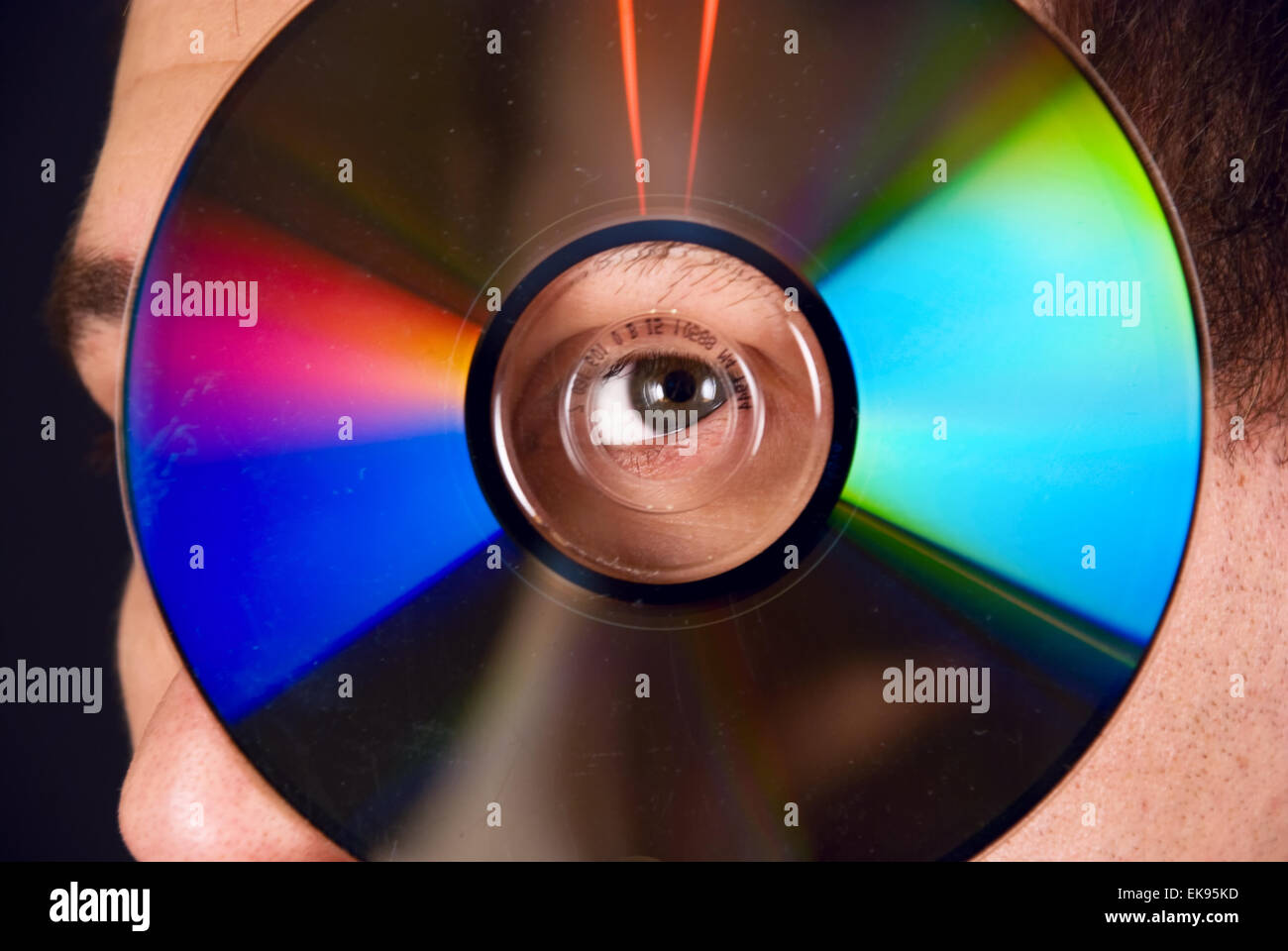 portrait of a man looking through a CD Stock Photo - Alamy