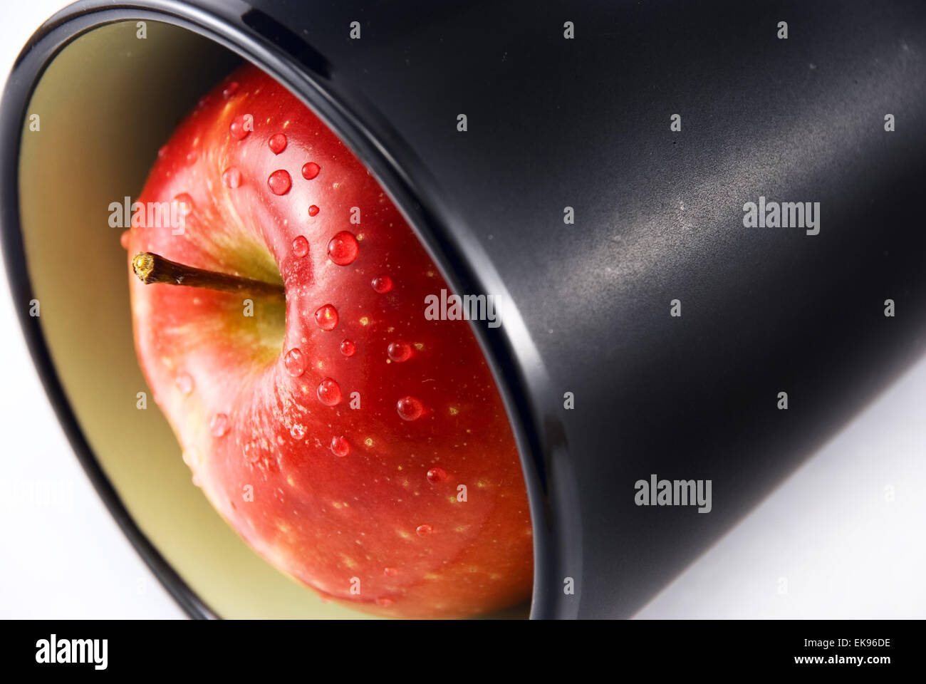 apple in a cup isolated on white Stock Photo - Alamy