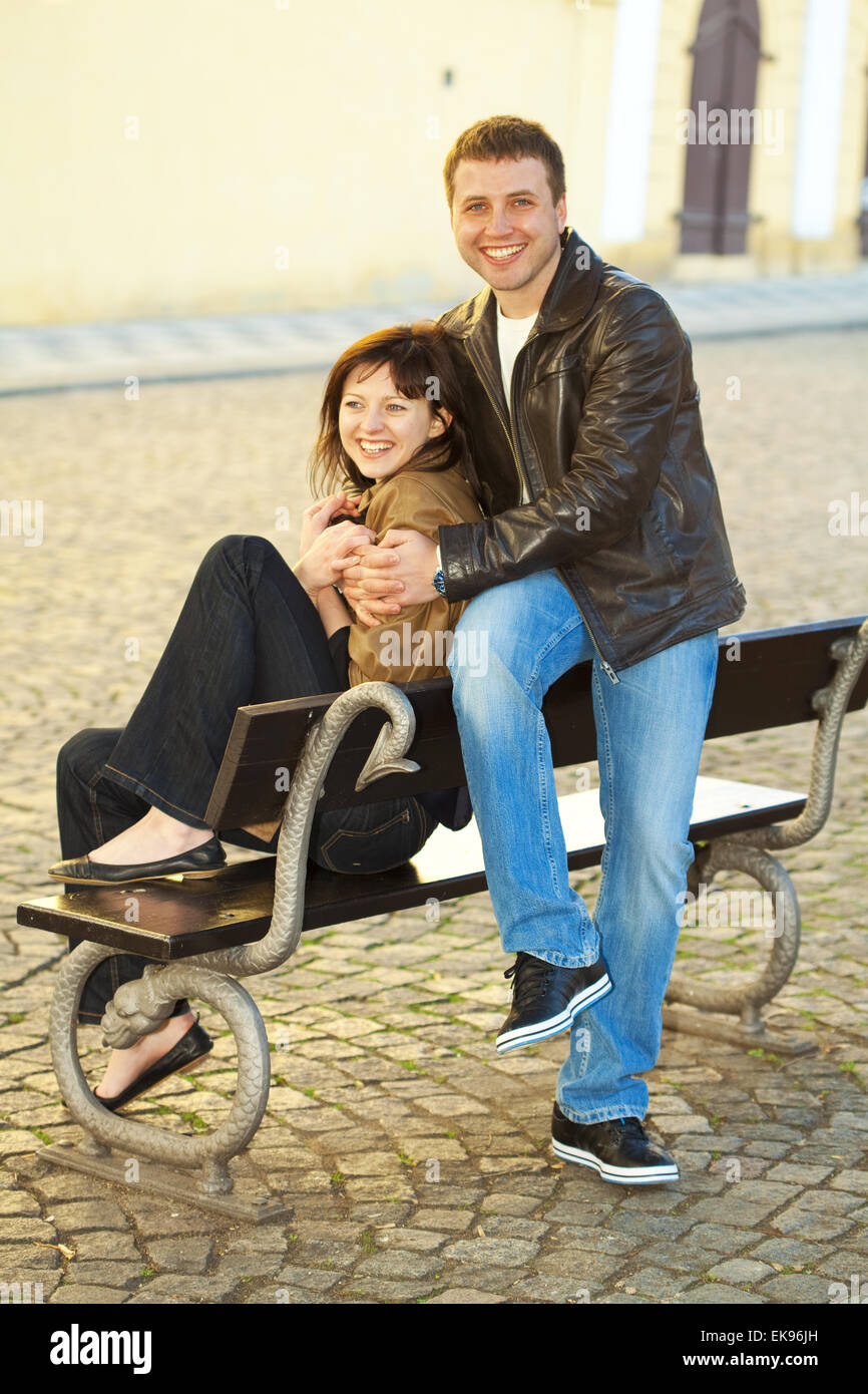 love couple sitting on a bench Stock Photo - Alamy