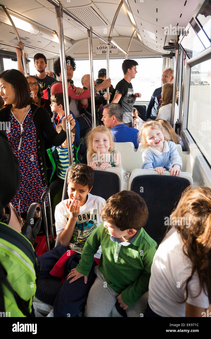 Passengers in shuttle bus take transfer coach (on apron) from departure ...