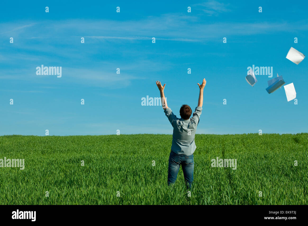 young man throwing a paper in the green field Stock Photo - Alamy