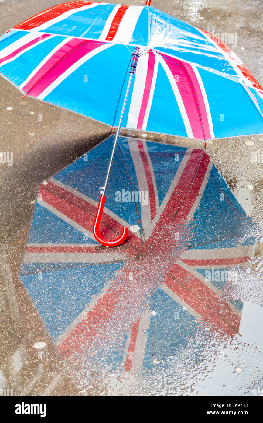 A Union Jack umbrella reflection in the rain on a London Street, London ...