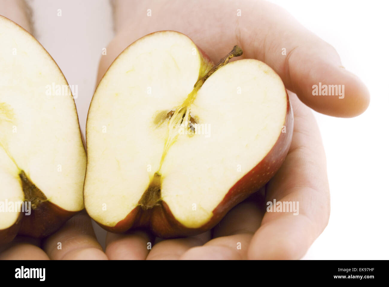 half an apple in hands isolated on white Stock Photo - Alamy