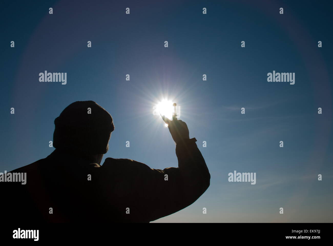 man holding a sun in his hands against the sky Stock Photo - Alamy