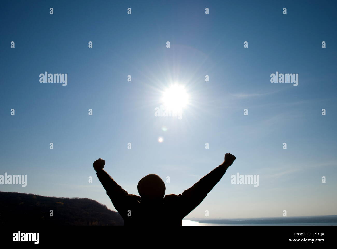 man with his arms apart against the blue sky Stock Photo - Alamy