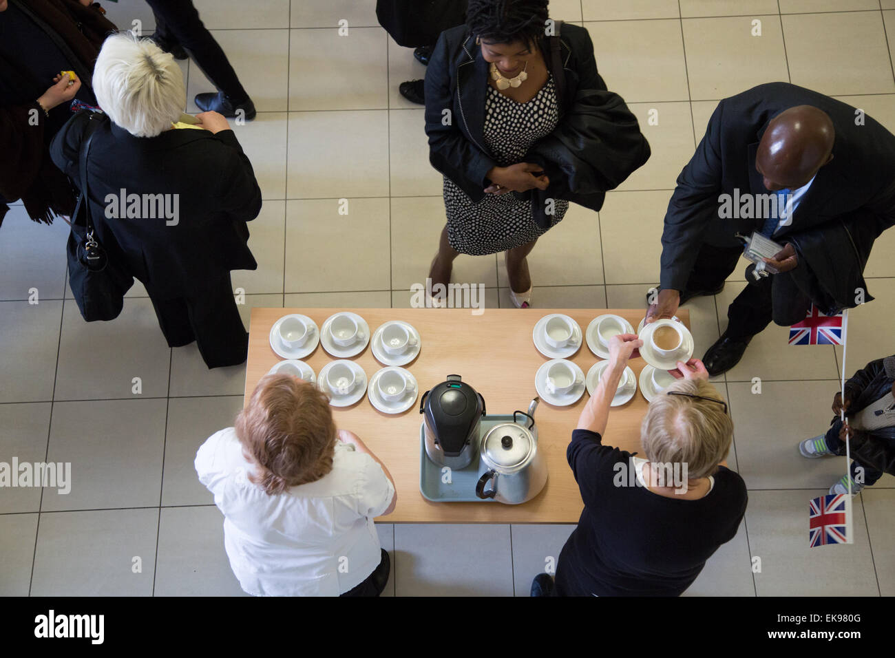 Overhead shot of people getting cups of tea from a table Stock Photo ...