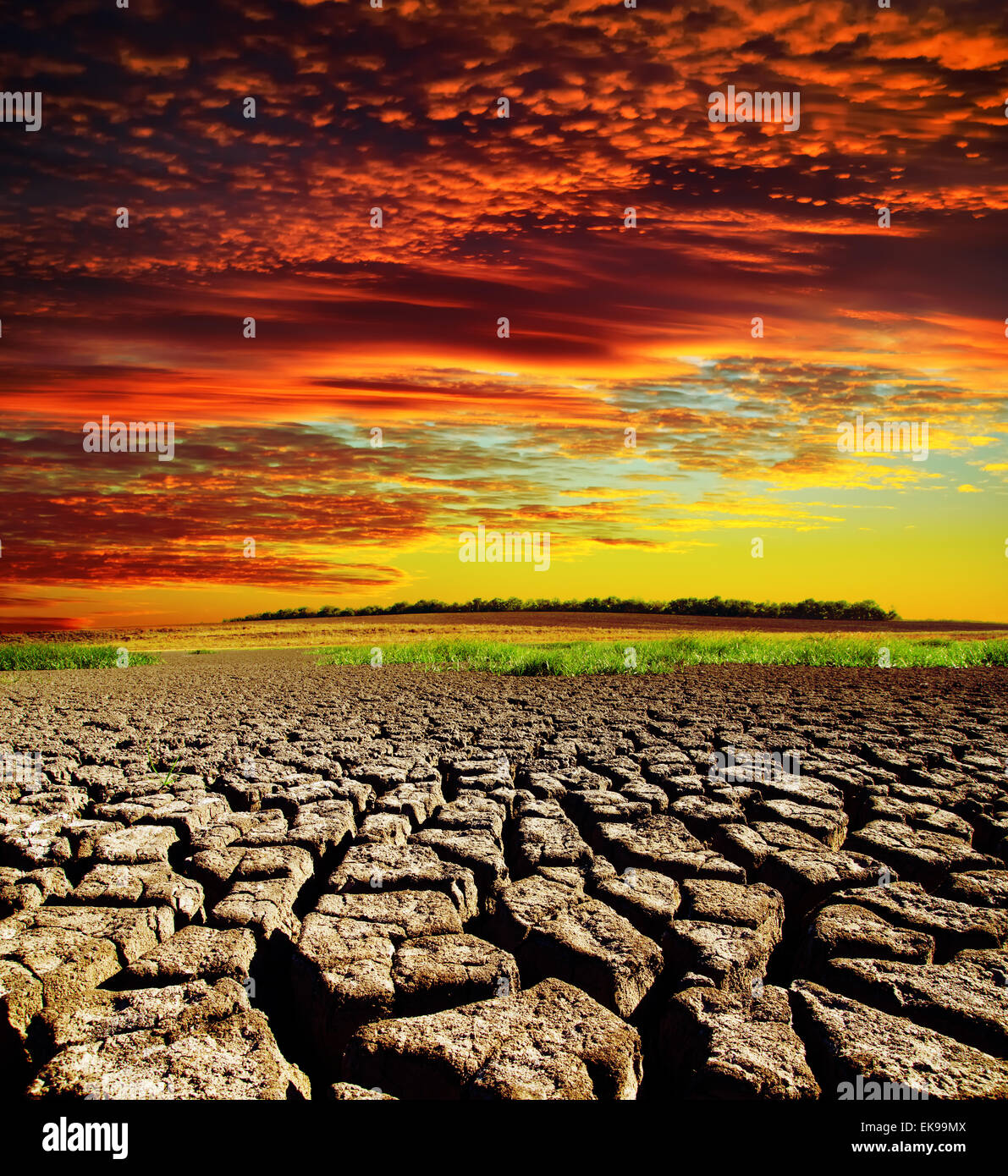 red dramatic sunset over dry cracked earth Stock Photo - Alamy