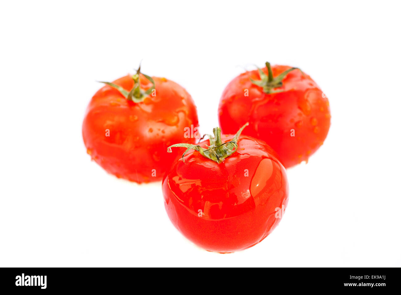 tomatoes under running water isolated on white Stock Photo - Alamy