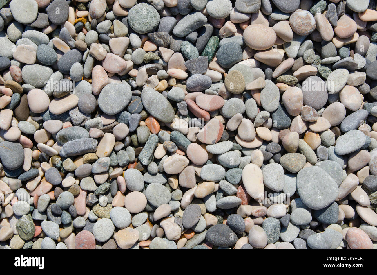 rounded stones on beach as background Stock Photo - Alamy