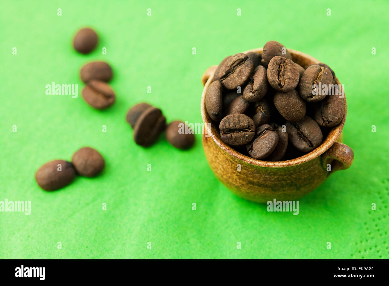 small pot of coffee beans on the green matter Stock Photo - Alamy