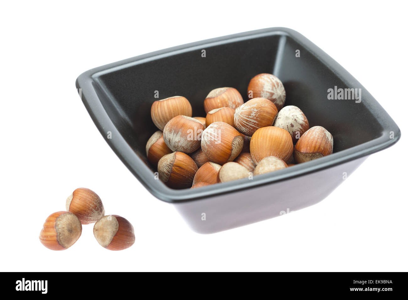 hazelnuts in a bowl isolated on white Stock Photo - Alamy