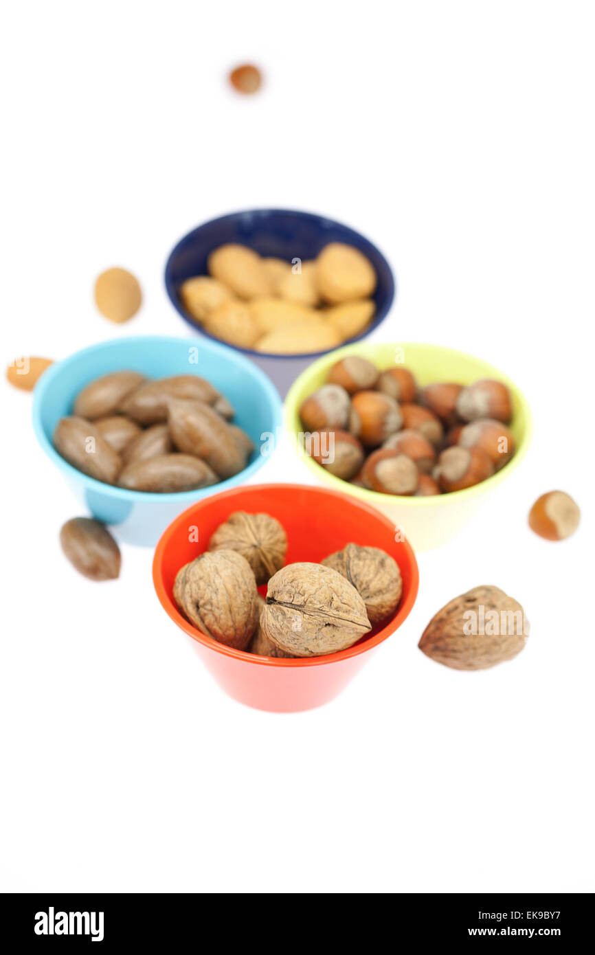 nuts in bowls isolated on white Stock Photo - Alamy