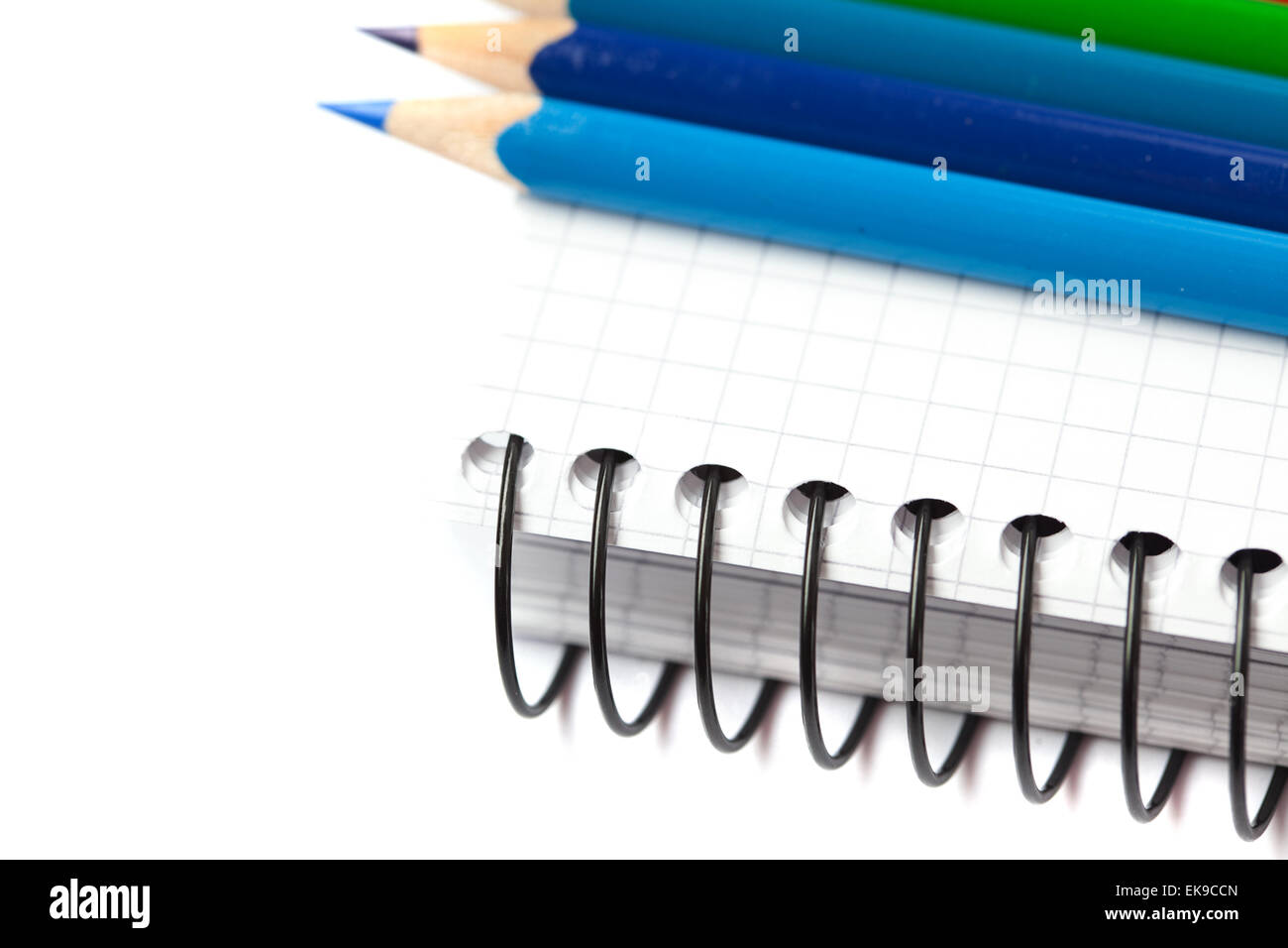 colored pencils and a notebook isolated on white Stock Photo - Alamy