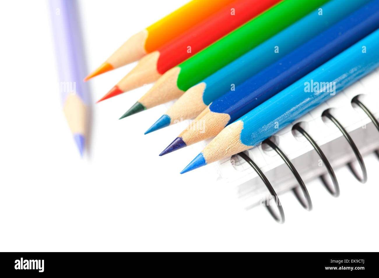 colored pencils and a notebook isolated on white Stock Photo - Alamy