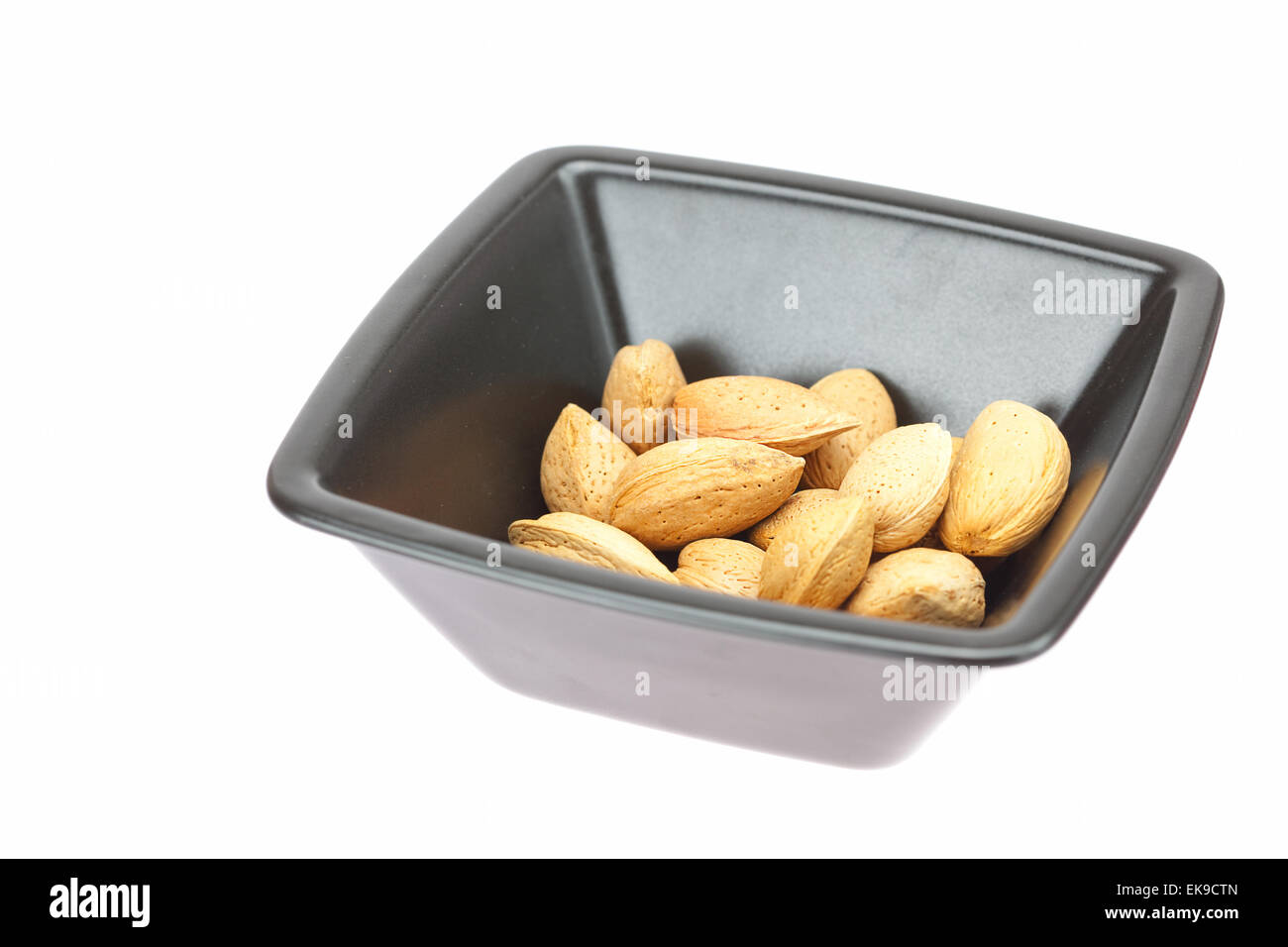 almonds in a bowl isolated on white Stock Photo - Alamy