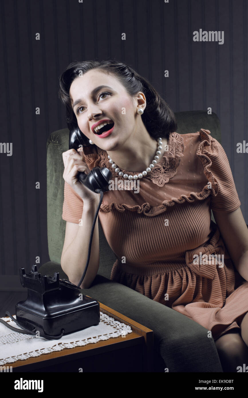 Happy woman talking on landline phone Stock Photo - Alamy