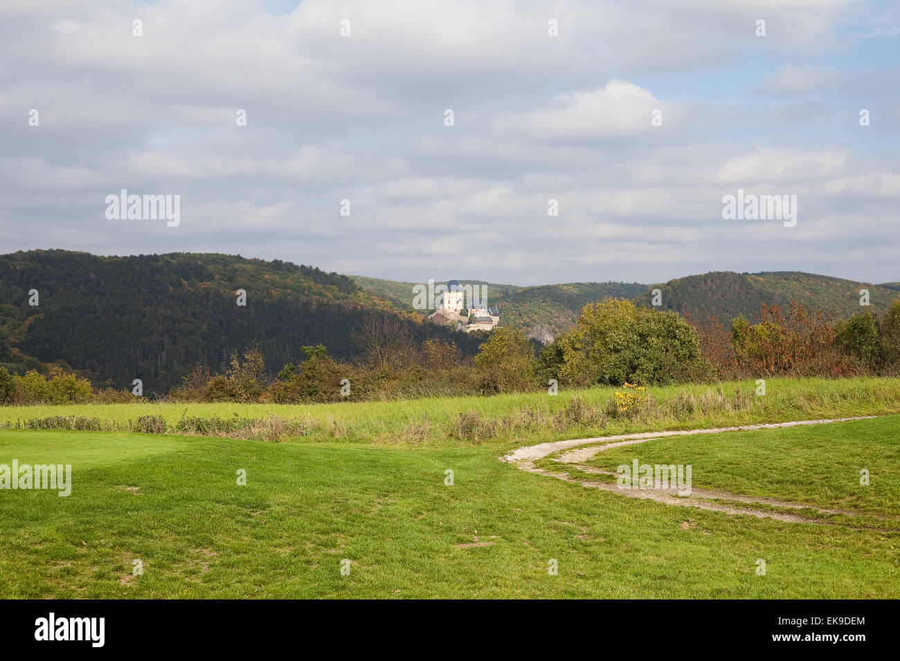 field on the background of a medieval castle and the hills Stock Photo ...