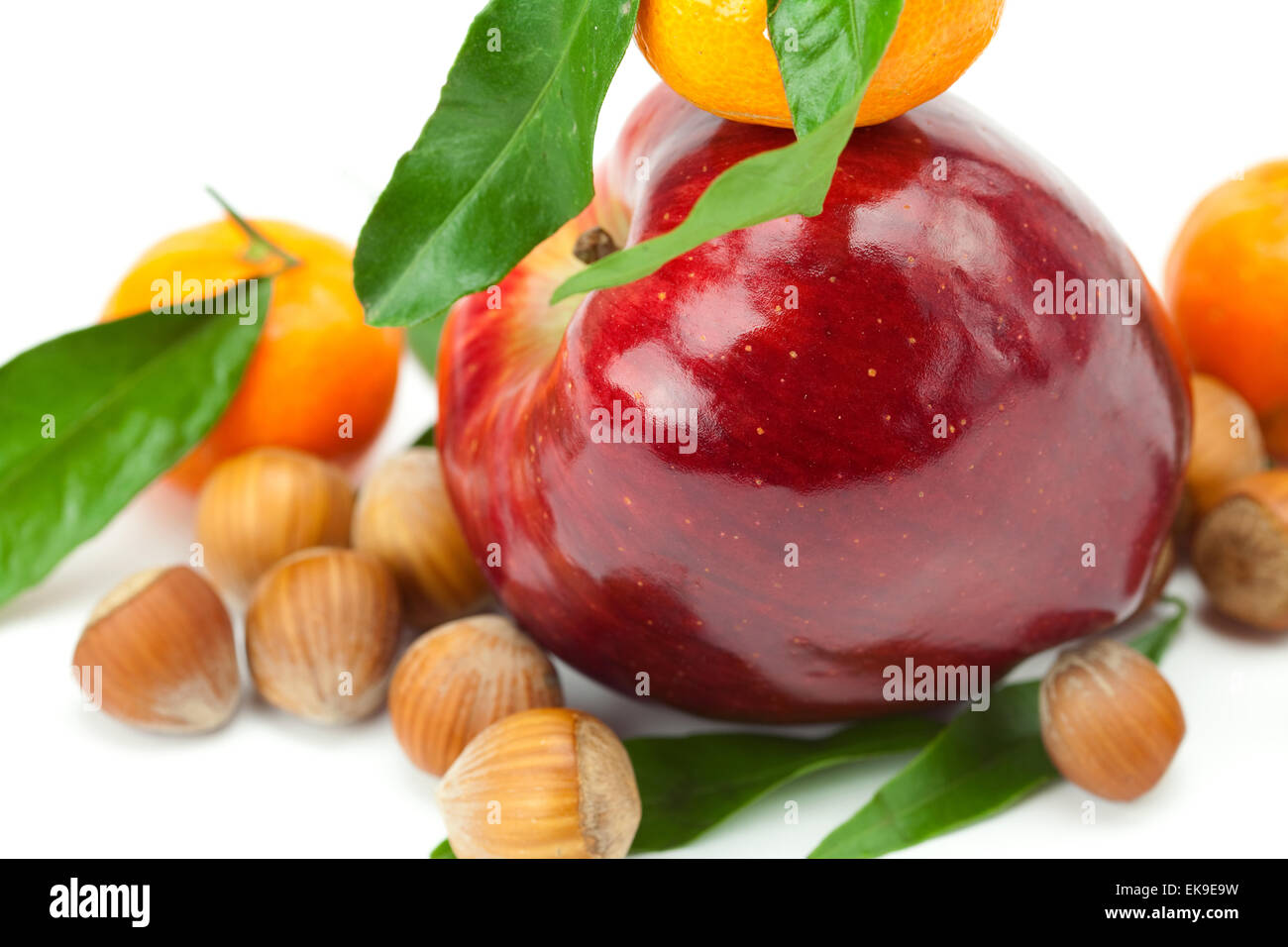 red apple, mandarin with green leaves and nuts isolated on whi Stock ...