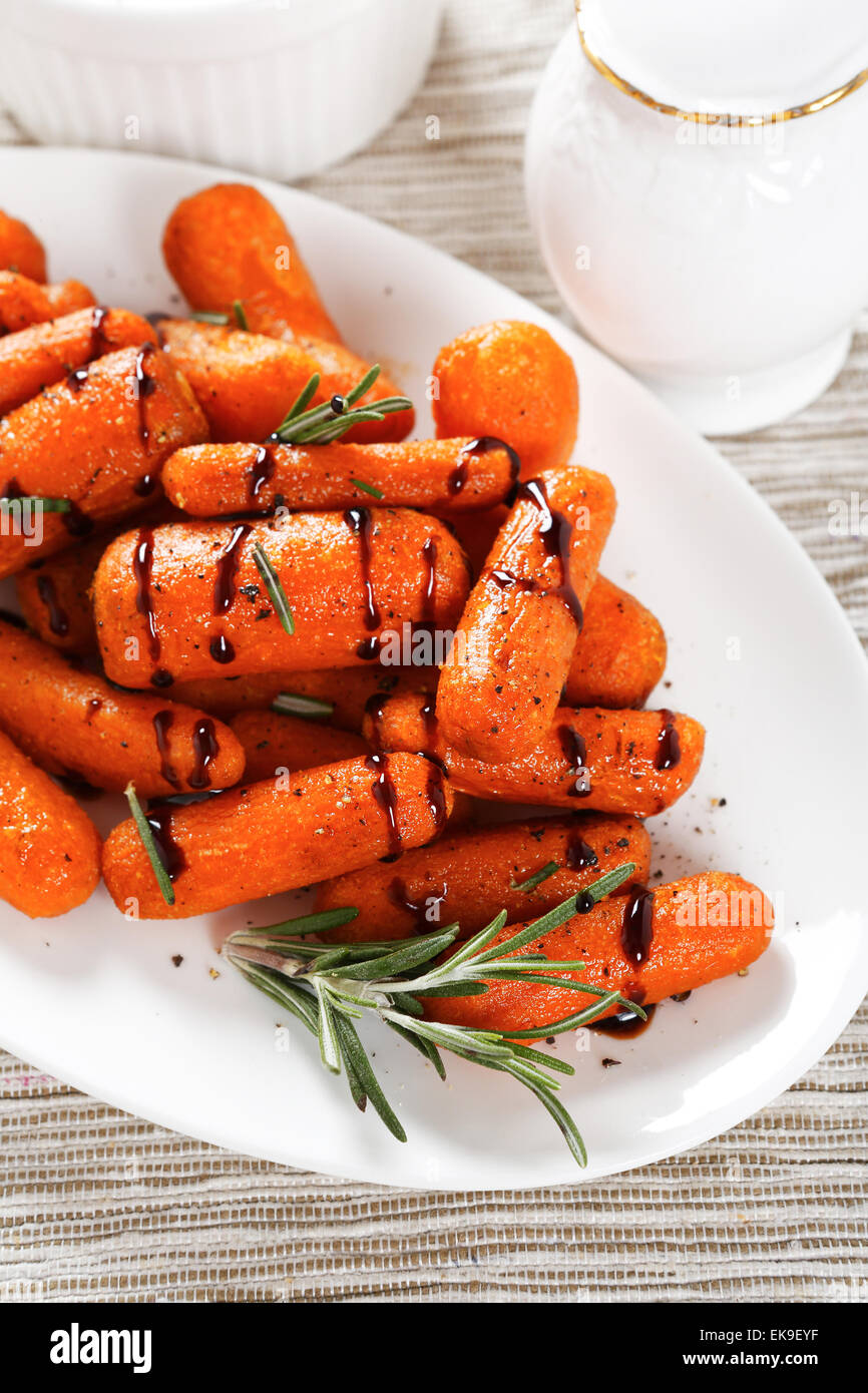 Baked small carrot on a plate, food Stock Photo - Alamy