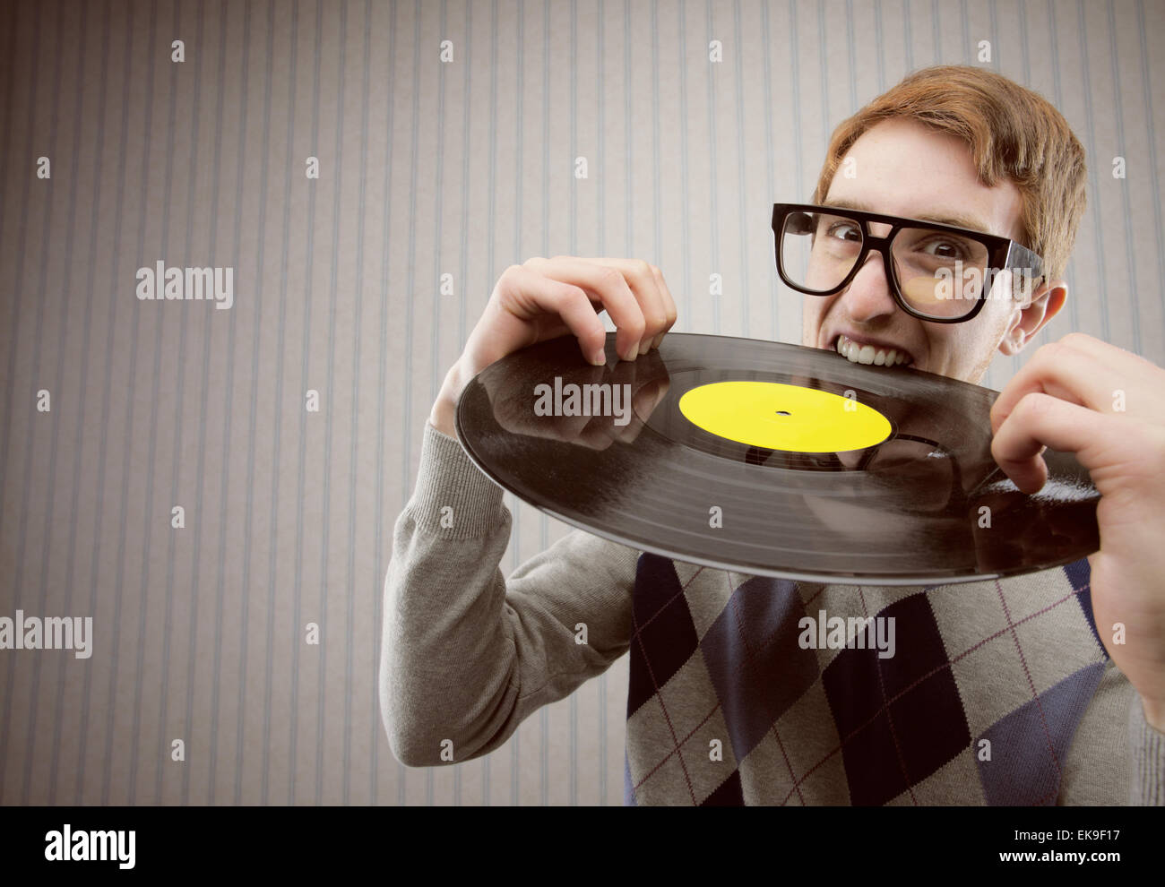 Nerd student angry, biting a vinyl record Stock Photo - Alamy