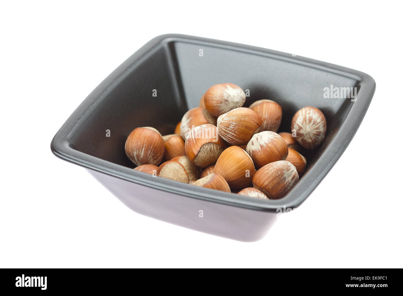hazelnuts in a bowl isolated on white Stock Photo - Alamy