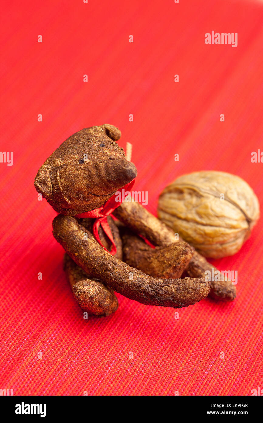Teddy bear handmade and nuts on a red background Stock Photo - Alamy