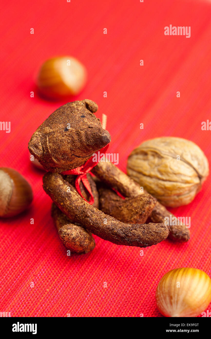 Teddy bear handmade and nuts on a red background Stock Photo - Alamy
