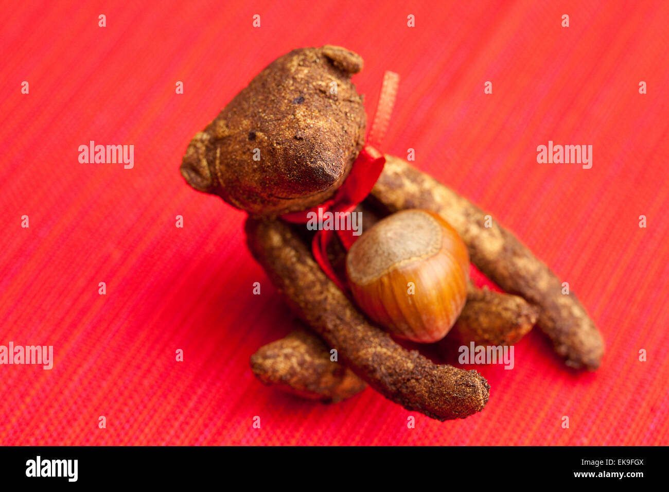 Teddy bear handmade and nuts on a red background Stock Photo - Alamy