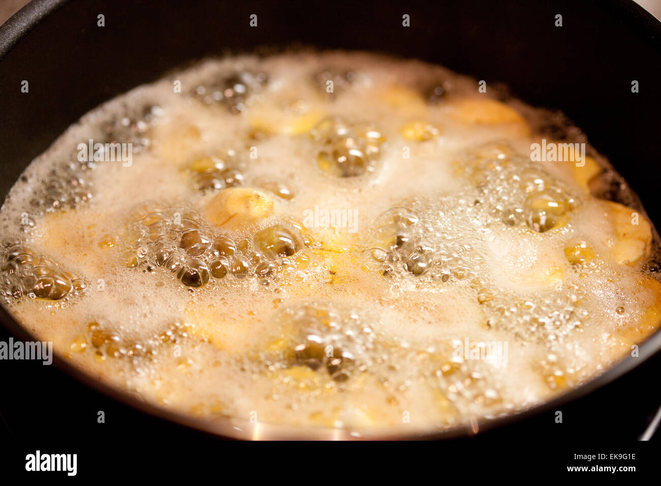 bananas in the pan in boiling caramel Stock Photo - Alamy