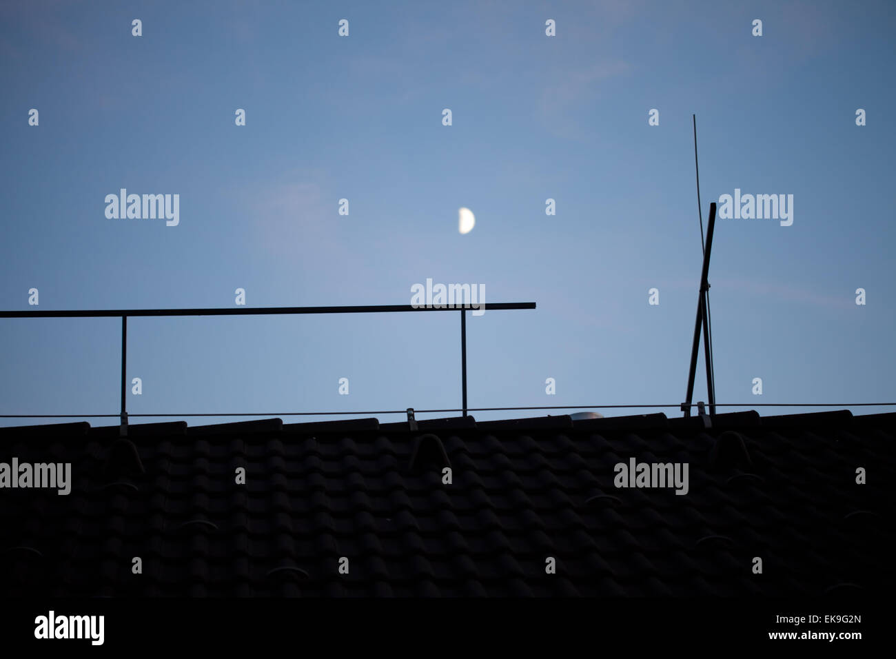 moon in the night sky above the roof Stock Photo - Alamy