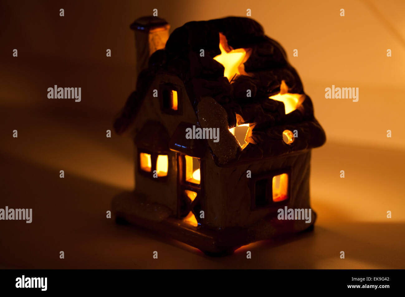 a decorative house with a candle inside Stock Photo - Alamy