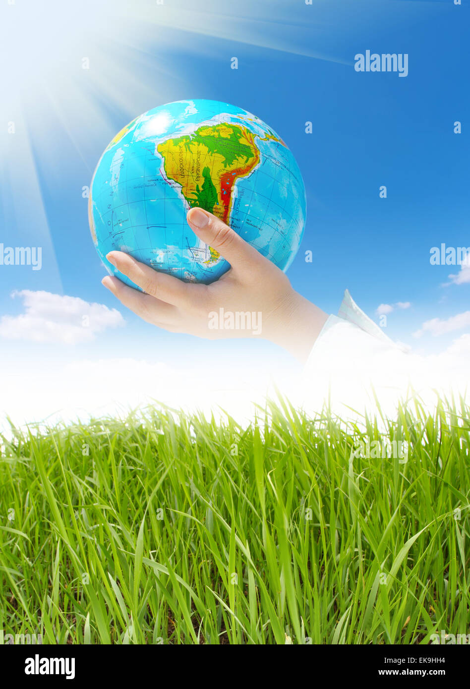 globe in hands under blue sky Stock Photo - Alamy