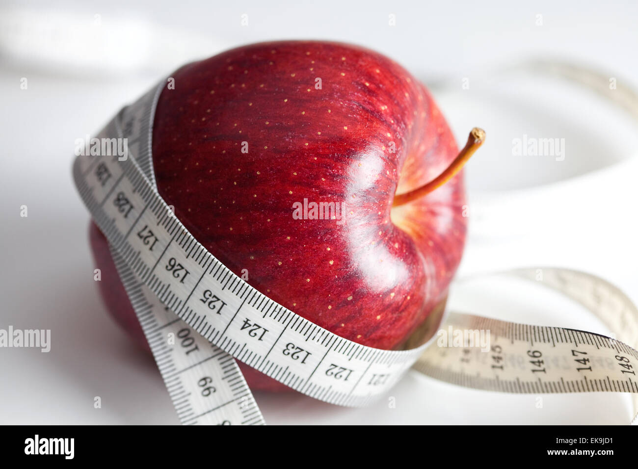 apple and measure tape isolated on white Stock Photo - Alamy