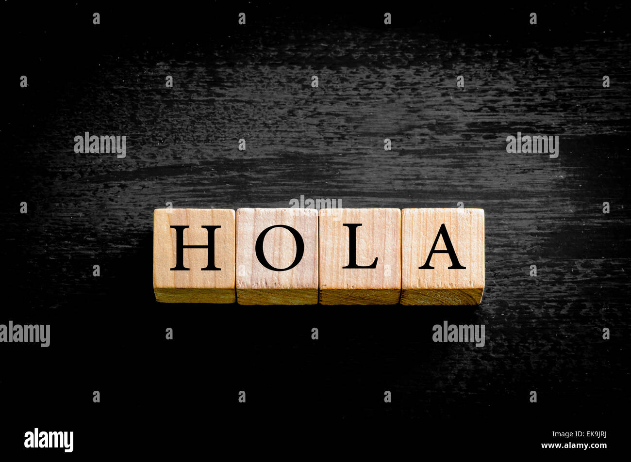 Word HOLA. Wooden small cubes with letters isolated on black background ...
