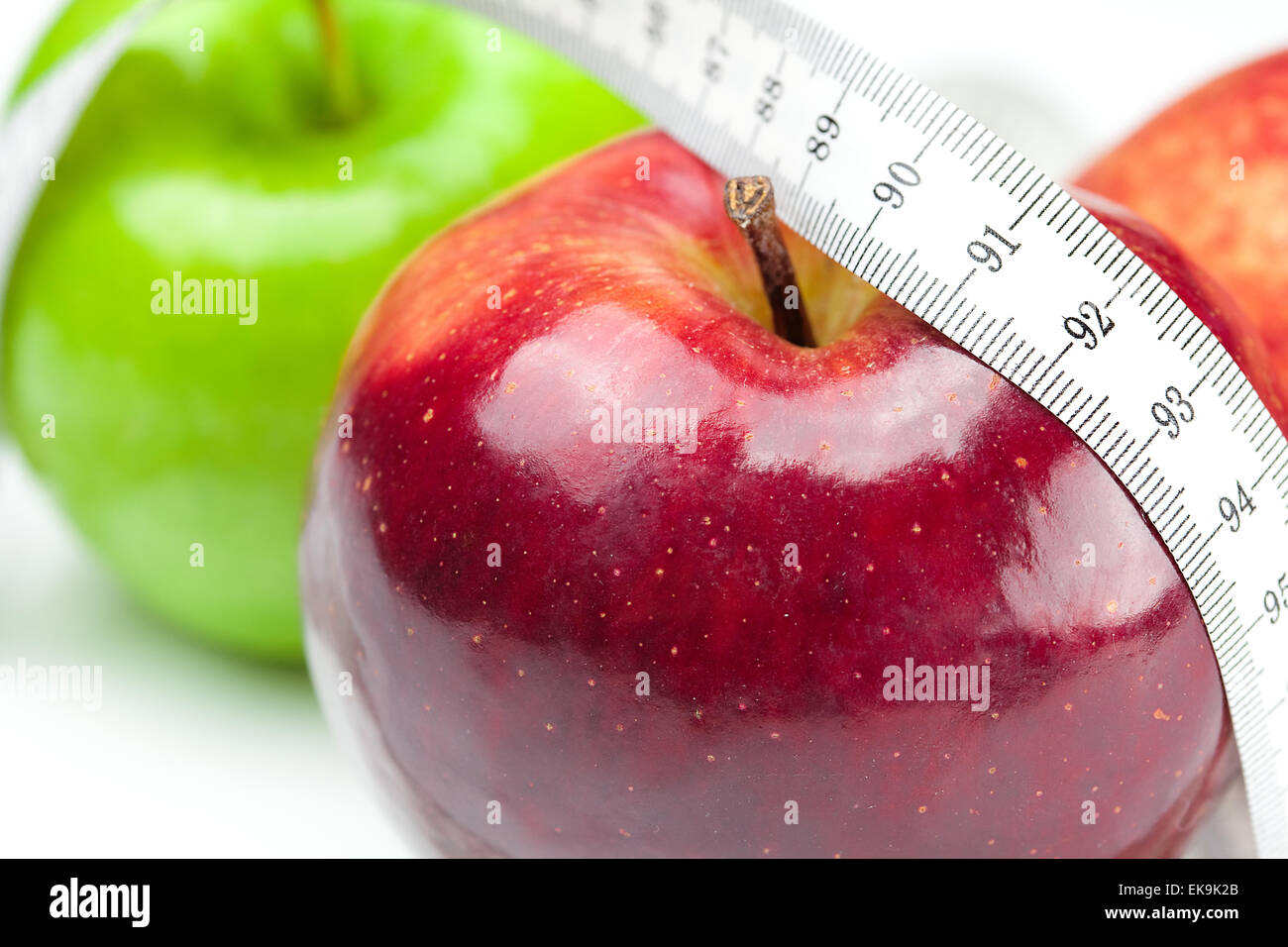 apple and measure tape isolated on white Stock Photo - Alamy