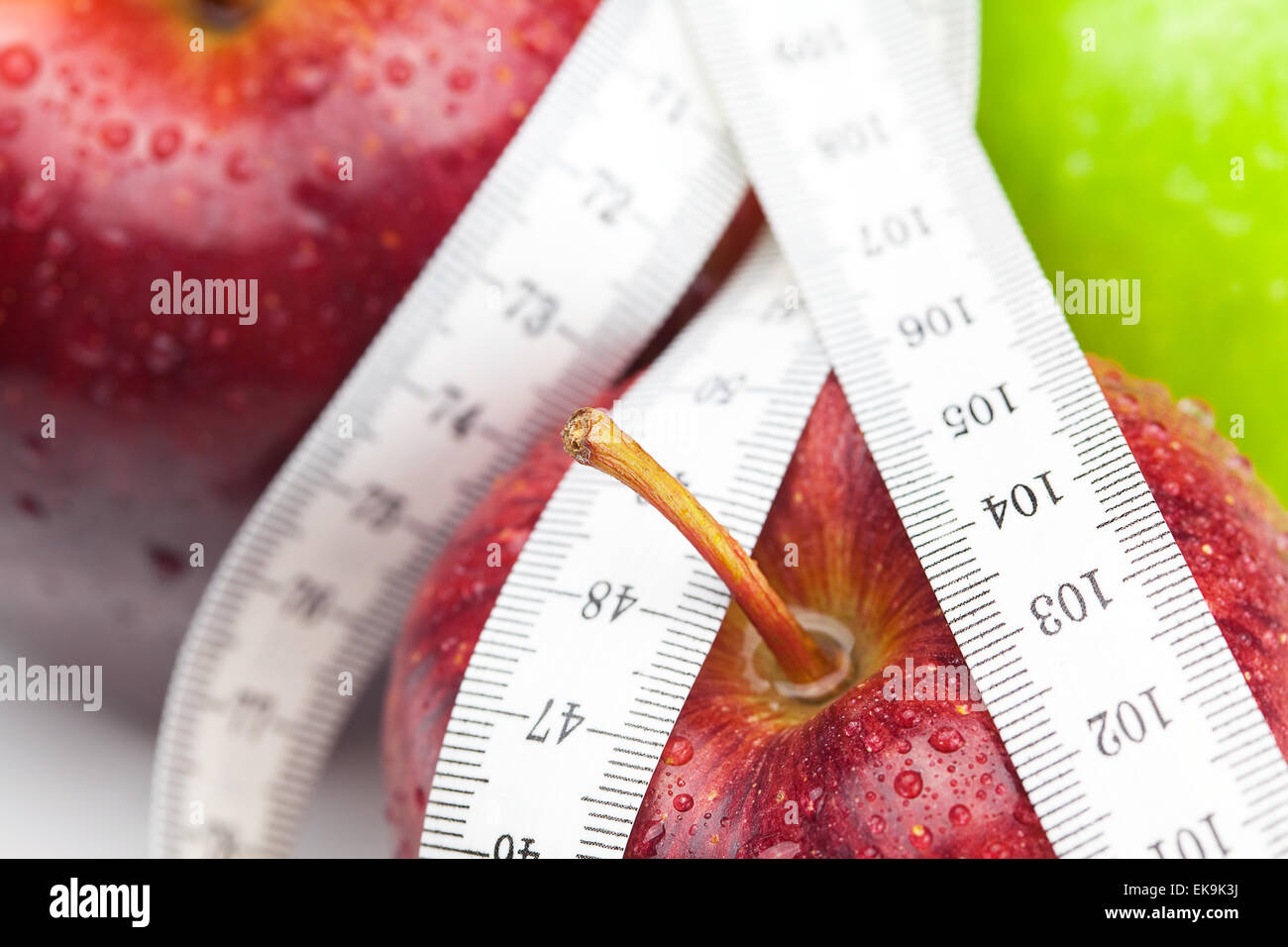 apple and measure tape isolated on white Stock Photo - Alamy
