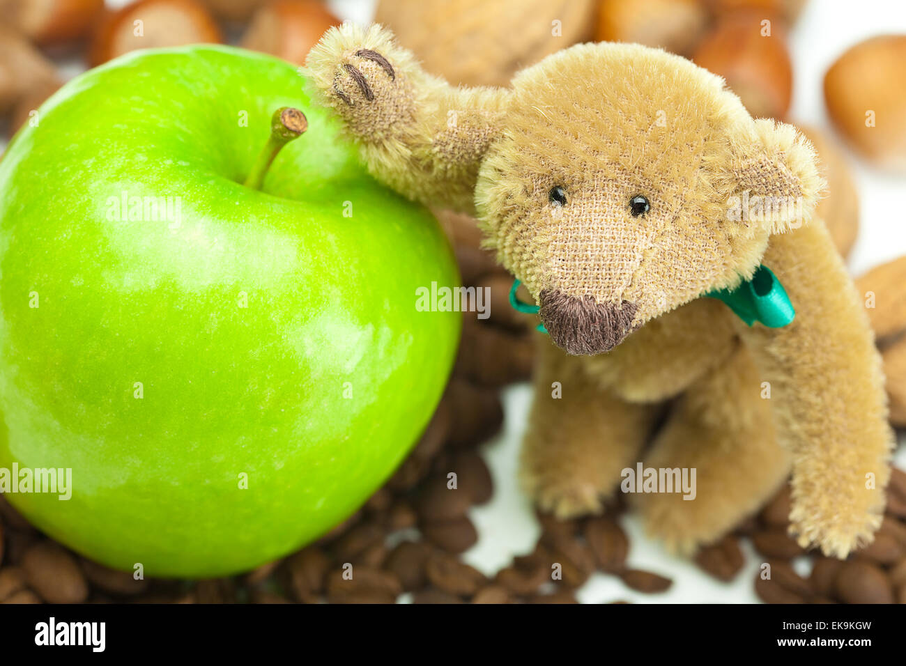 teddy bear with a bow,apple, coffee beans and nuts Stock Photo - Alamy