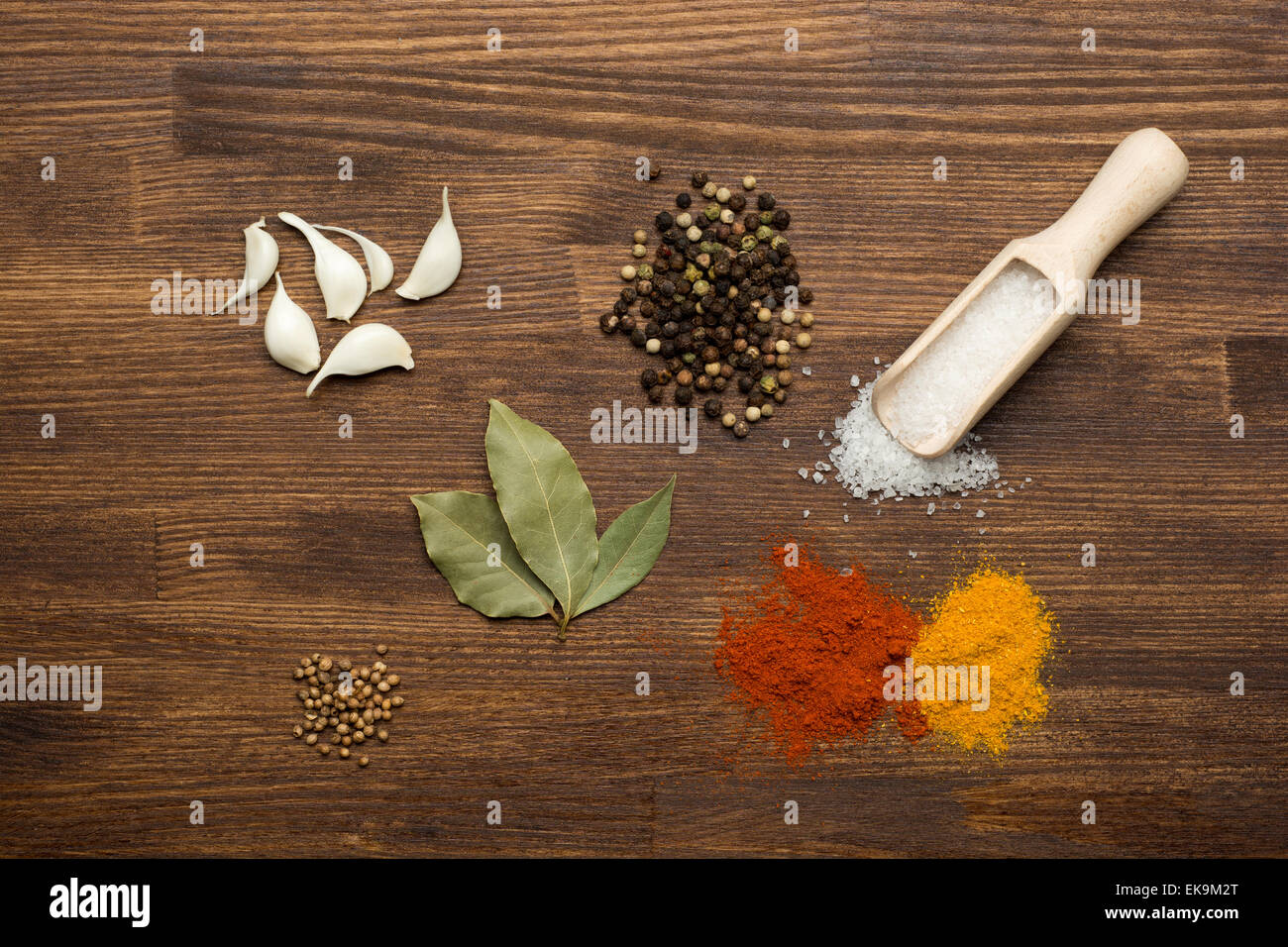 Colorful spices on rustic wooden table Stock Photo - Alamy